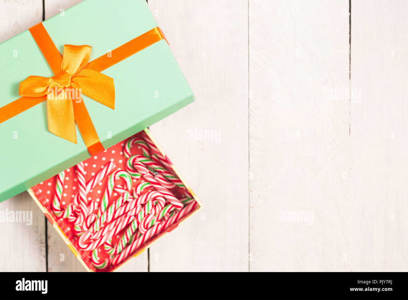 Lots of candy canes in gift box with big bow. Chtistmas theme Stock ...