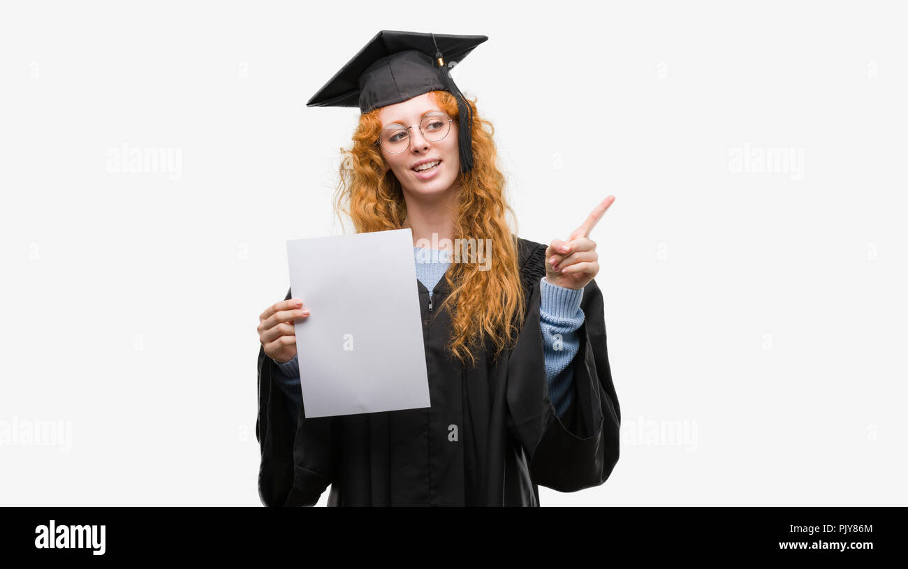 Young redhead woman wearing graduate uniform holding degree very happy ...