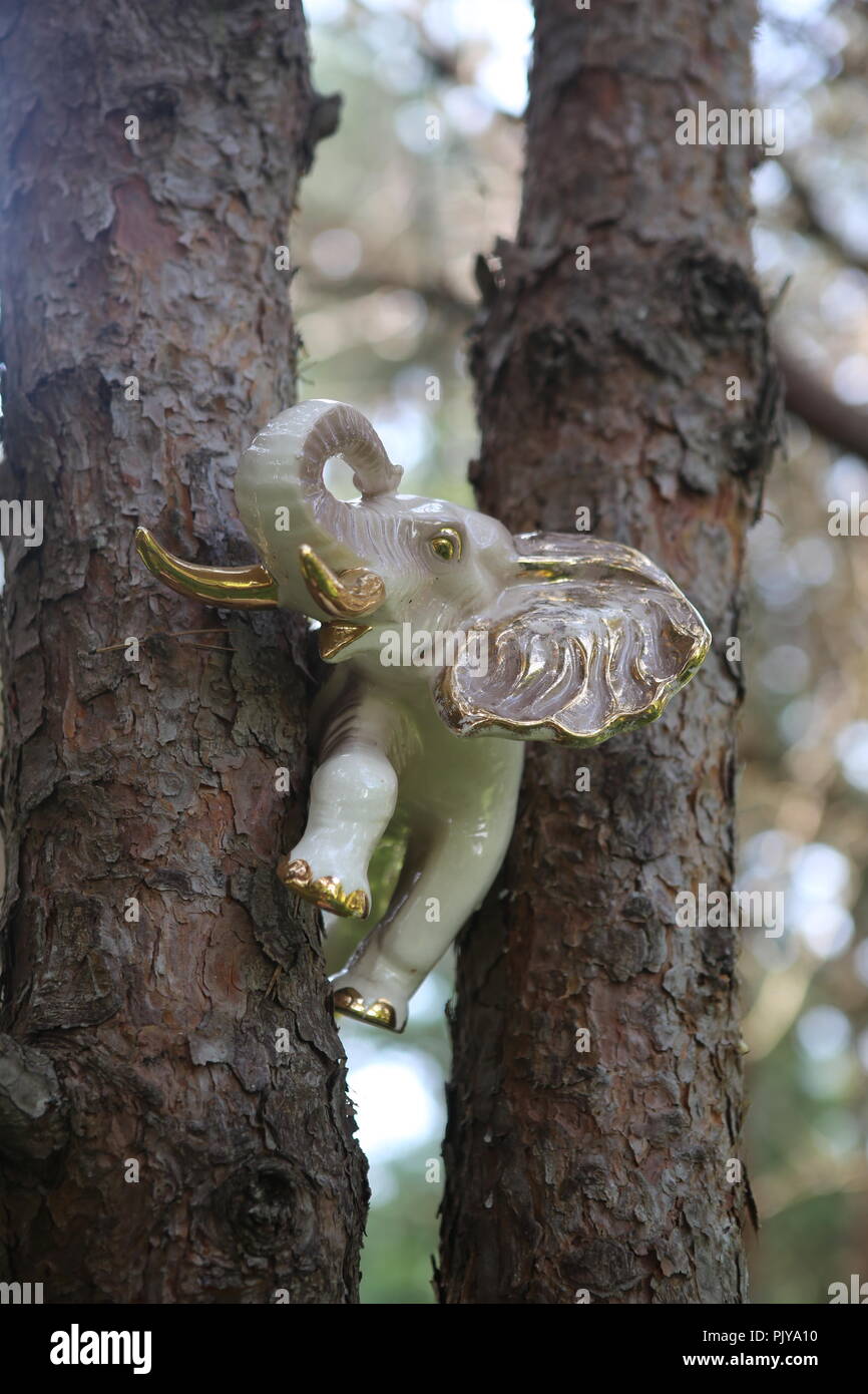 elephant decorations in tree garden Stock Photo - Alamy