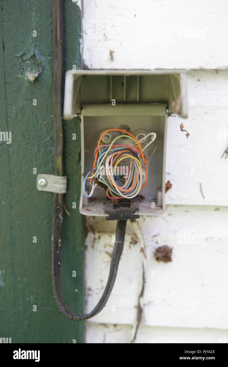 electric wires outside building facade wall Stock Photo - Alamy