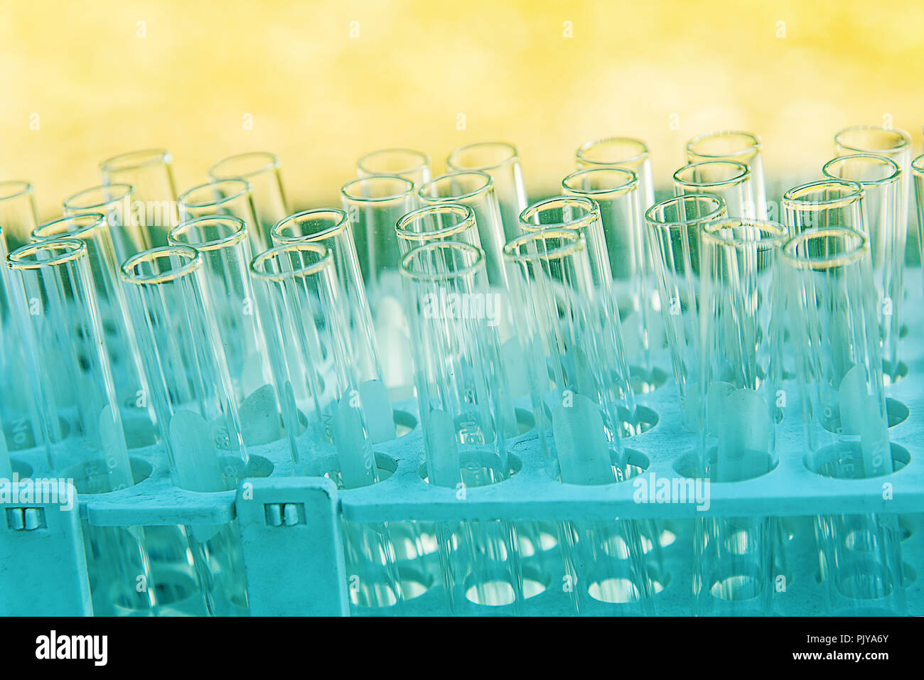 Lab science research glass items adding drop to one of several test ...