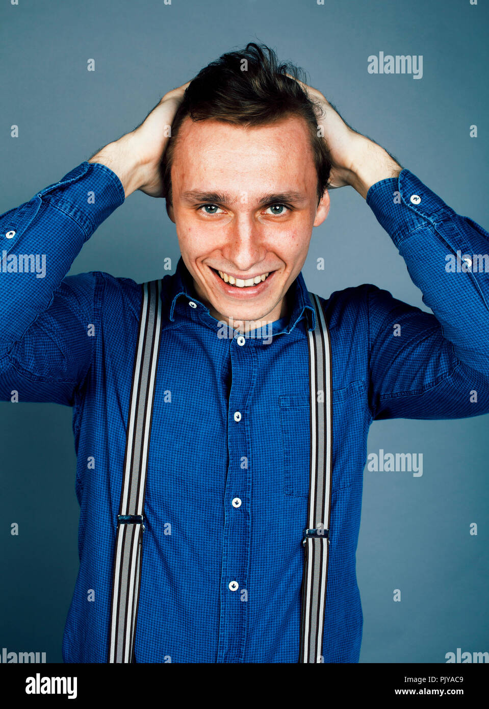 young goofy man with pimples pointing in studio Stock Photo - Alamy