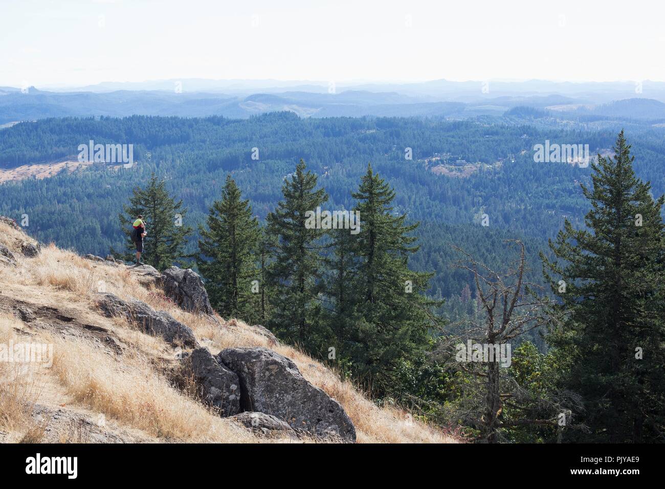A man with a small child hiking on top of Spencer Butte in Eugene ...
