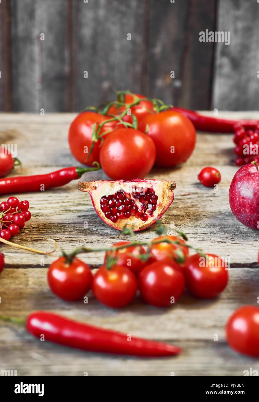 Assorted types of red vegetables and fruits on wooden background Stock ...