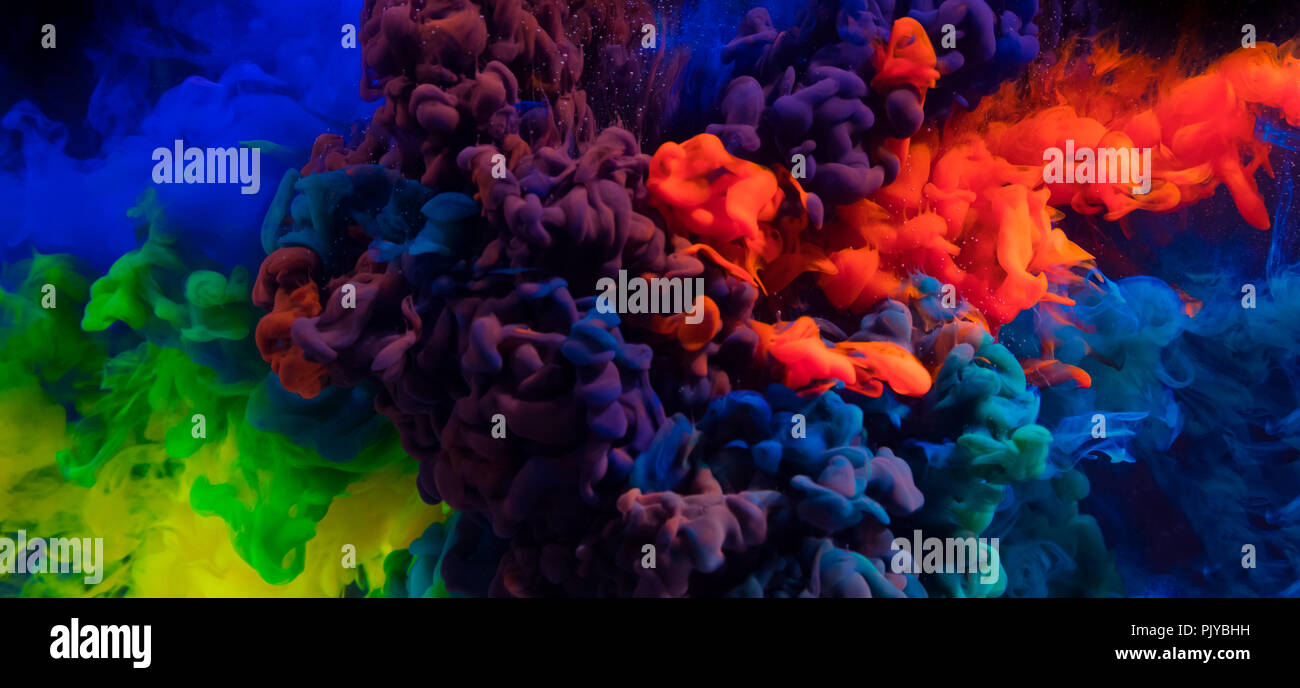 Mix of coloured inks in water on black background. Abstract colored ...