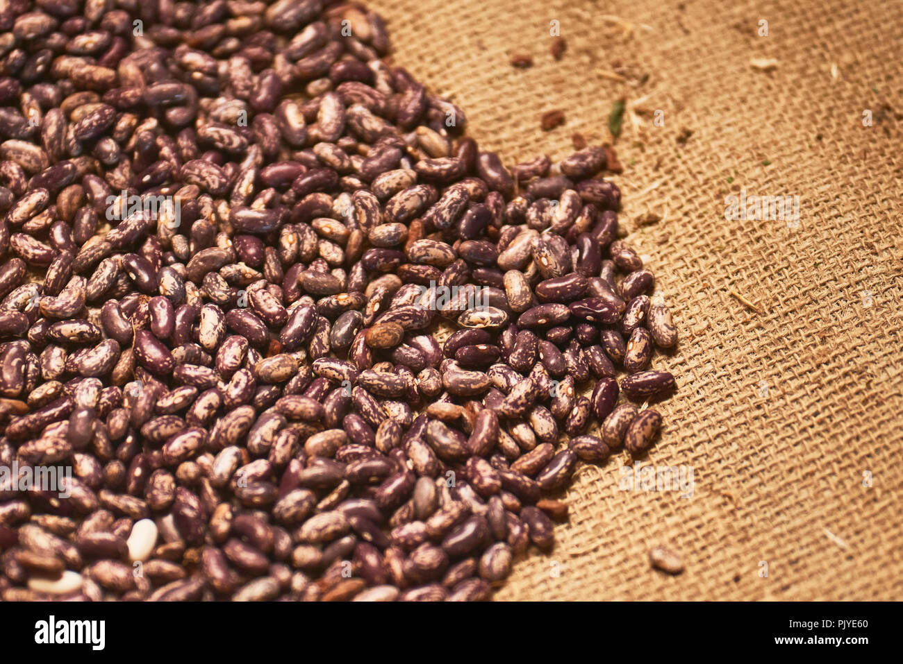 A lot of beans over rustic background Stock Photo - Alamy