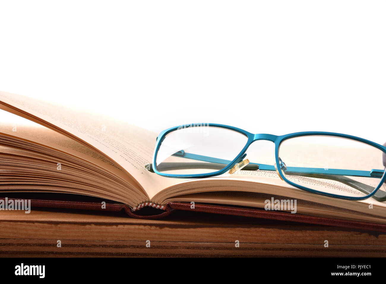 Reading glasses on wood table with open book. Concept need glasses to ...