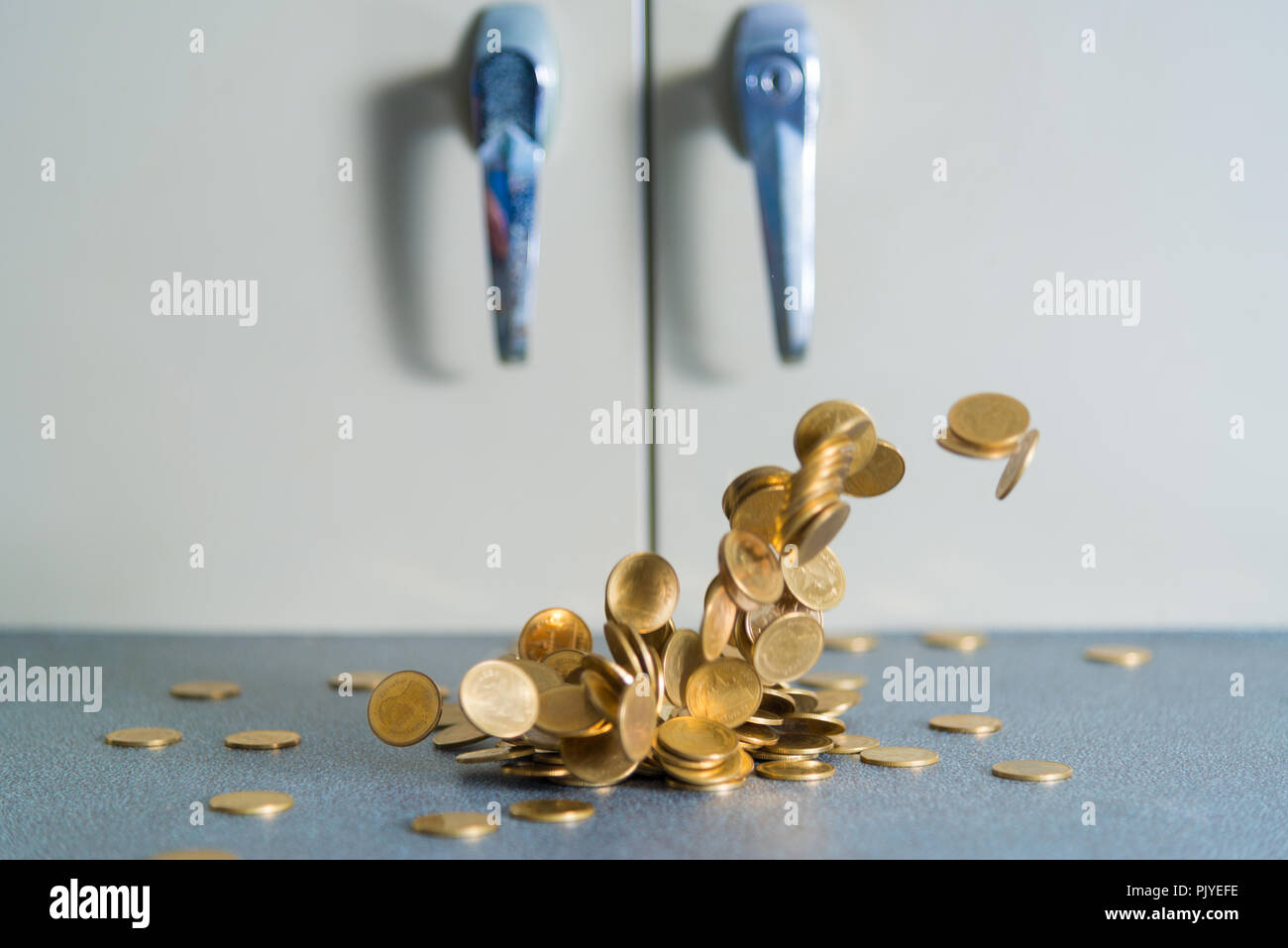 Falling gold coins money on office table with document cabinet ...