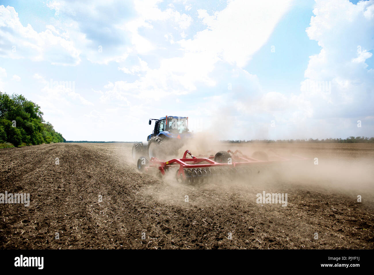the tractor plows a field Stock Photo - Alamy