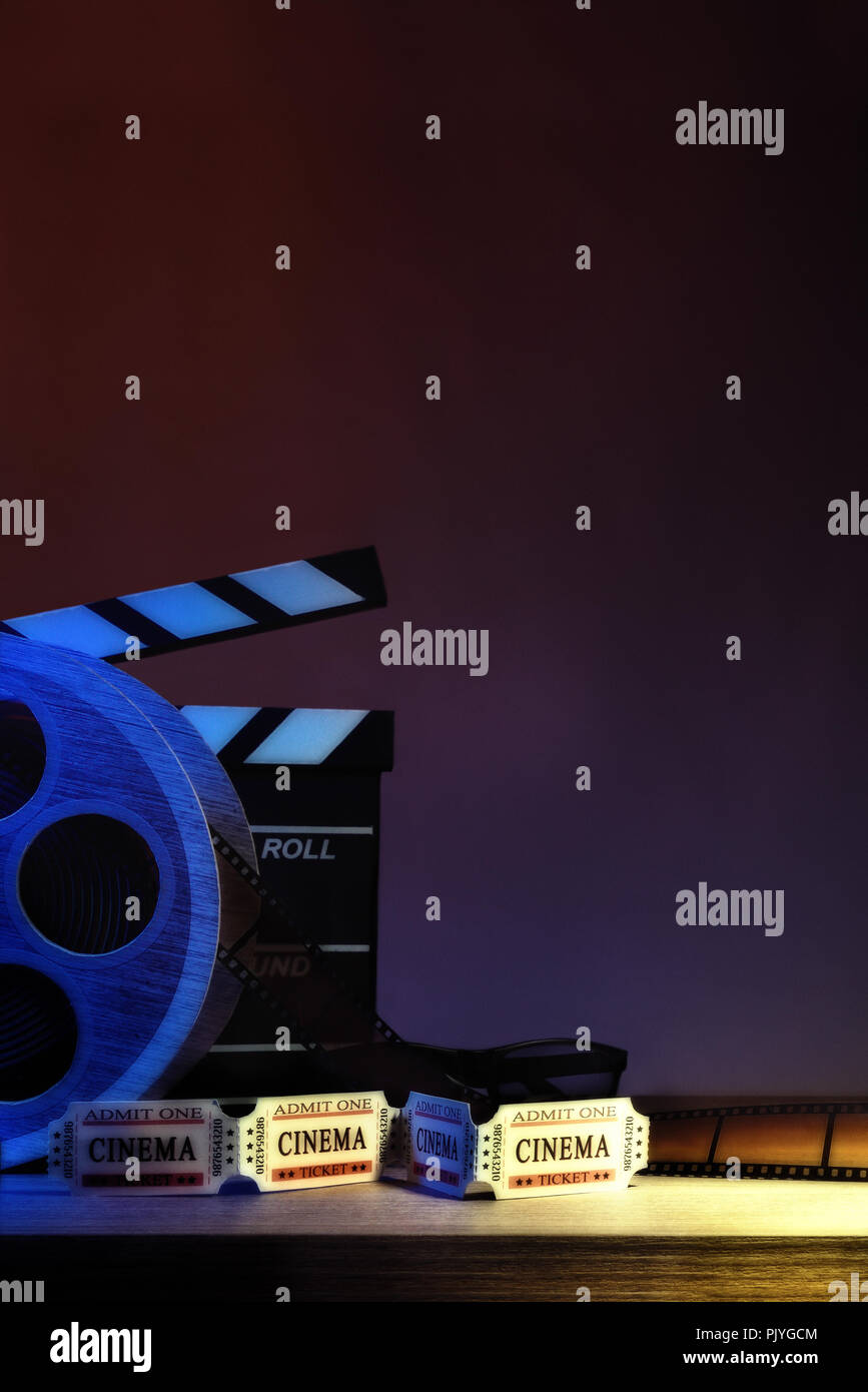 Equipment and elements of cinema on wooden table and dark blue ...