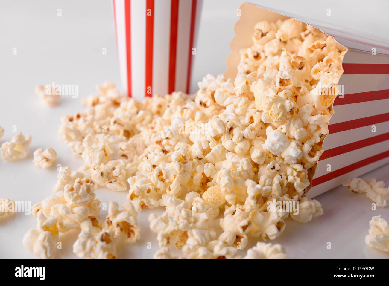 Popcorn in cardboard box with white background. Horizontal composition ...