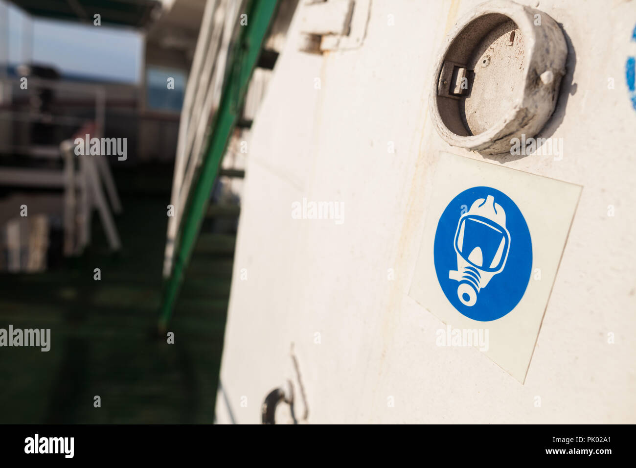 Color image of a gas mask sign on a white wall Stock Photo - Alamy