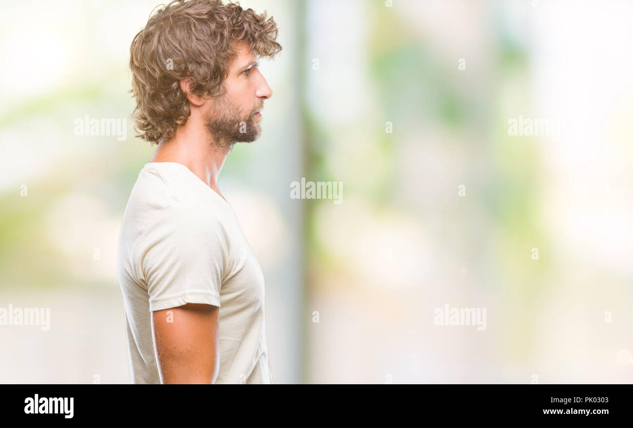 Handsome hispanic model man over isolated background looking to side ...
