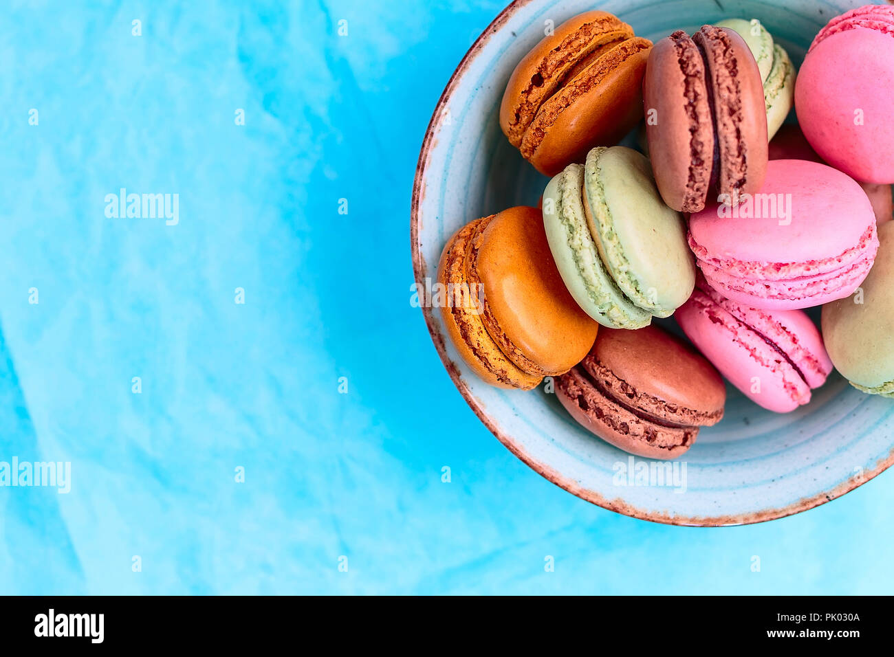 Cake macaron or macaroon bowl on turquoise blue background, pastel ...