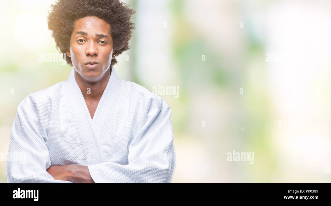Afro american man wearing karate kimono over isolated background ...