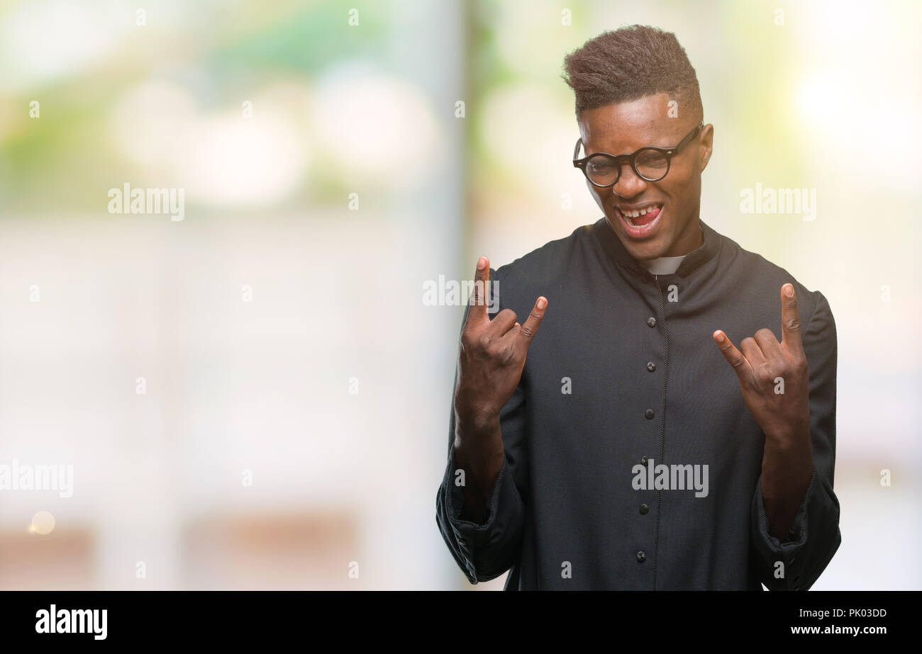 Young african american priest man over isolated background shouting ...
