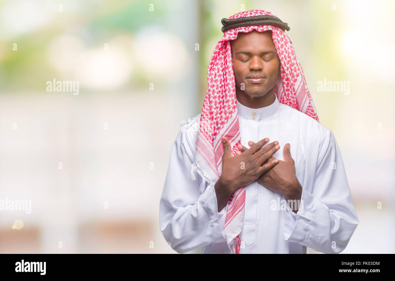 Young arabic african man wearing traditional keffiyeh over isolated ...