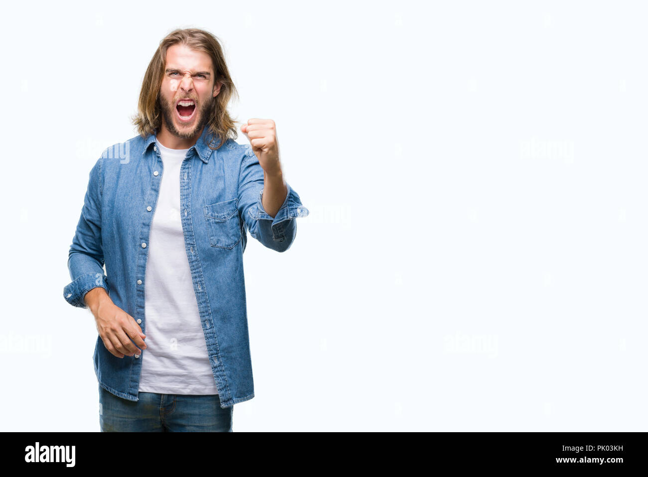 Young handsome man with long hair over isolated background angry and ...