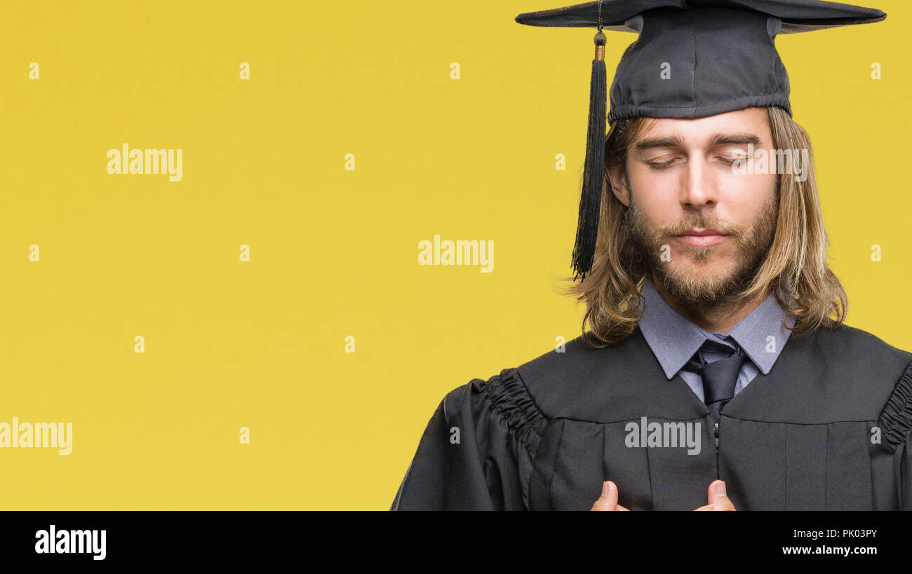 Young handsome graduated man with long hair over isolated background ...