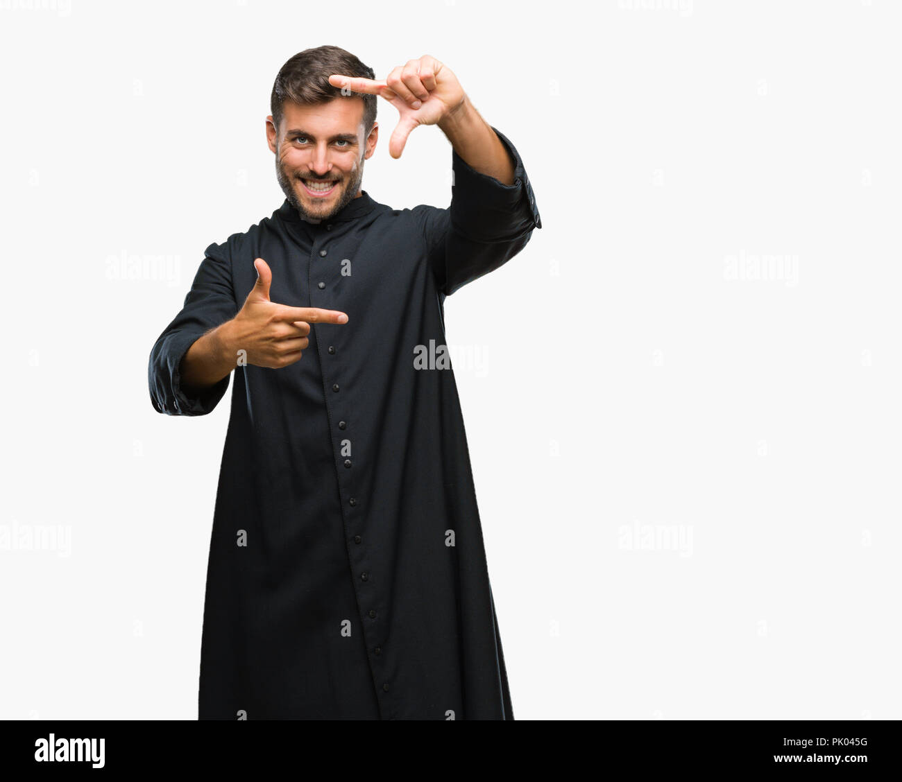 Young catholic christian priest man over isolated background smiling ...
