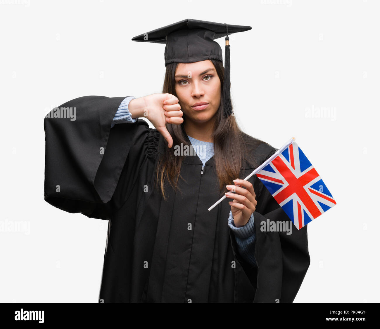 Young hispanic woman wearing graduated uniform holding flag of united ...