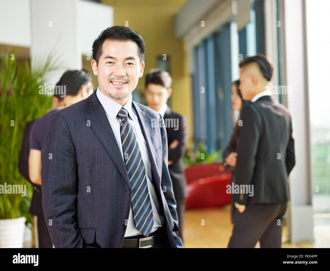 portrait of a senior business manager arms crossed looking at camera ...
