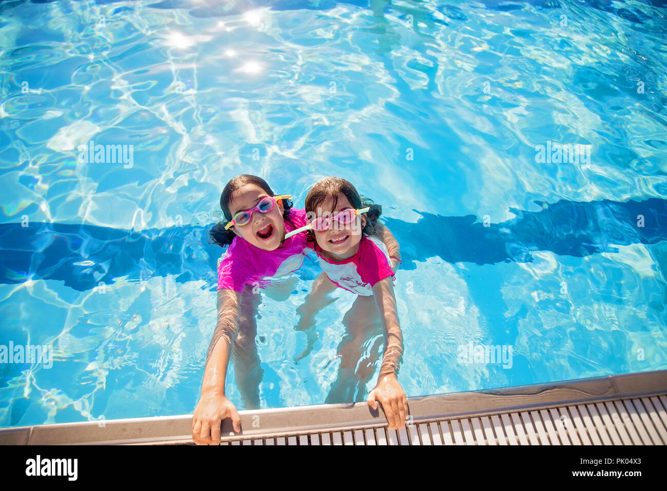 Girls swimming in pool Stock Photo - Alamy