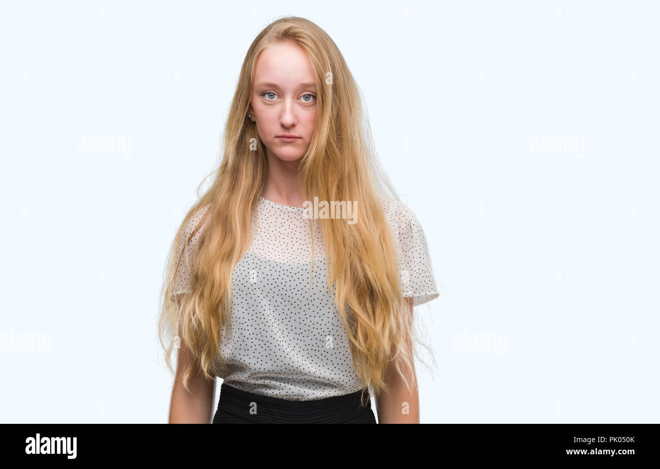 Blonde teenager woman wearing moles shirt depressed and worry for ...