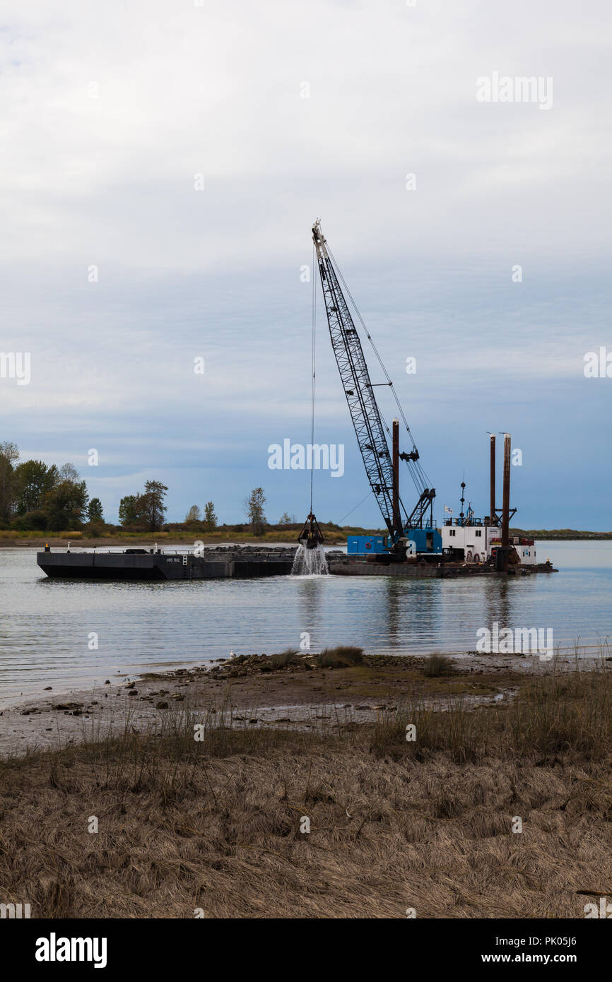Dredging the navigable entrance to Steveston Harbour on the Fraser ...