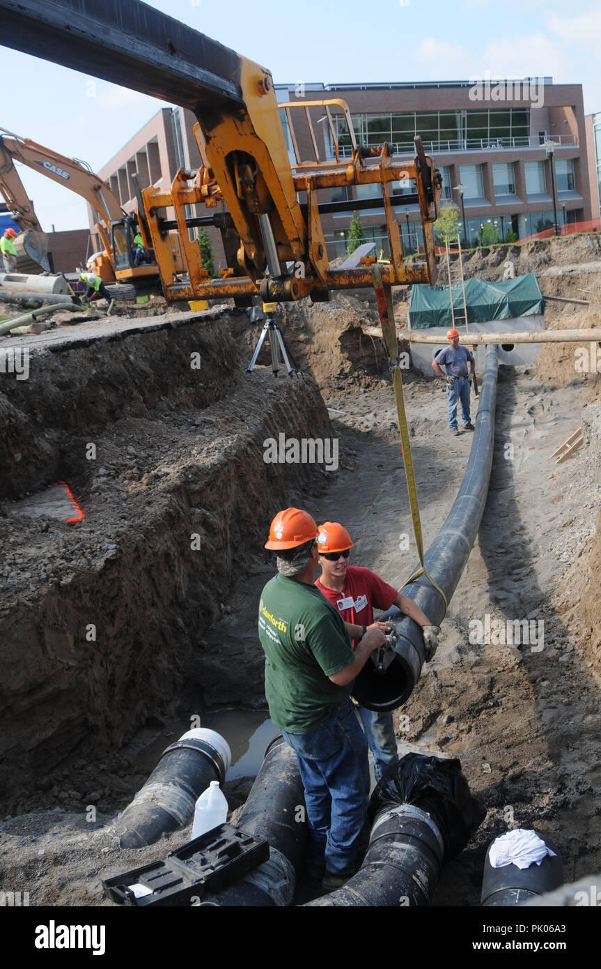 Laying pipe on a commercial construction site Stock Photo - Alamy