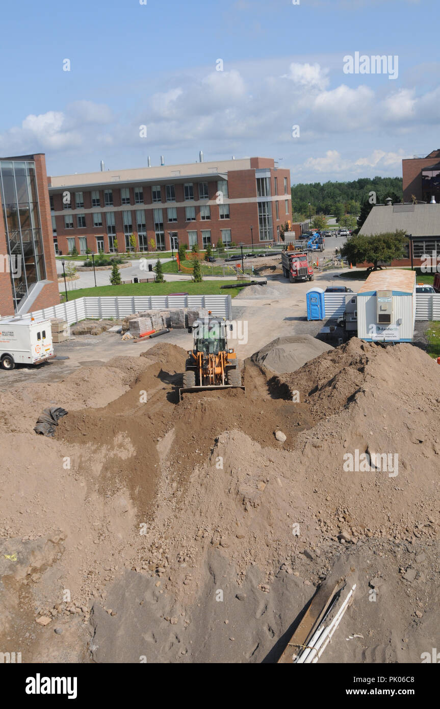 Moving earth on a construction site Stock Photo - Alamy