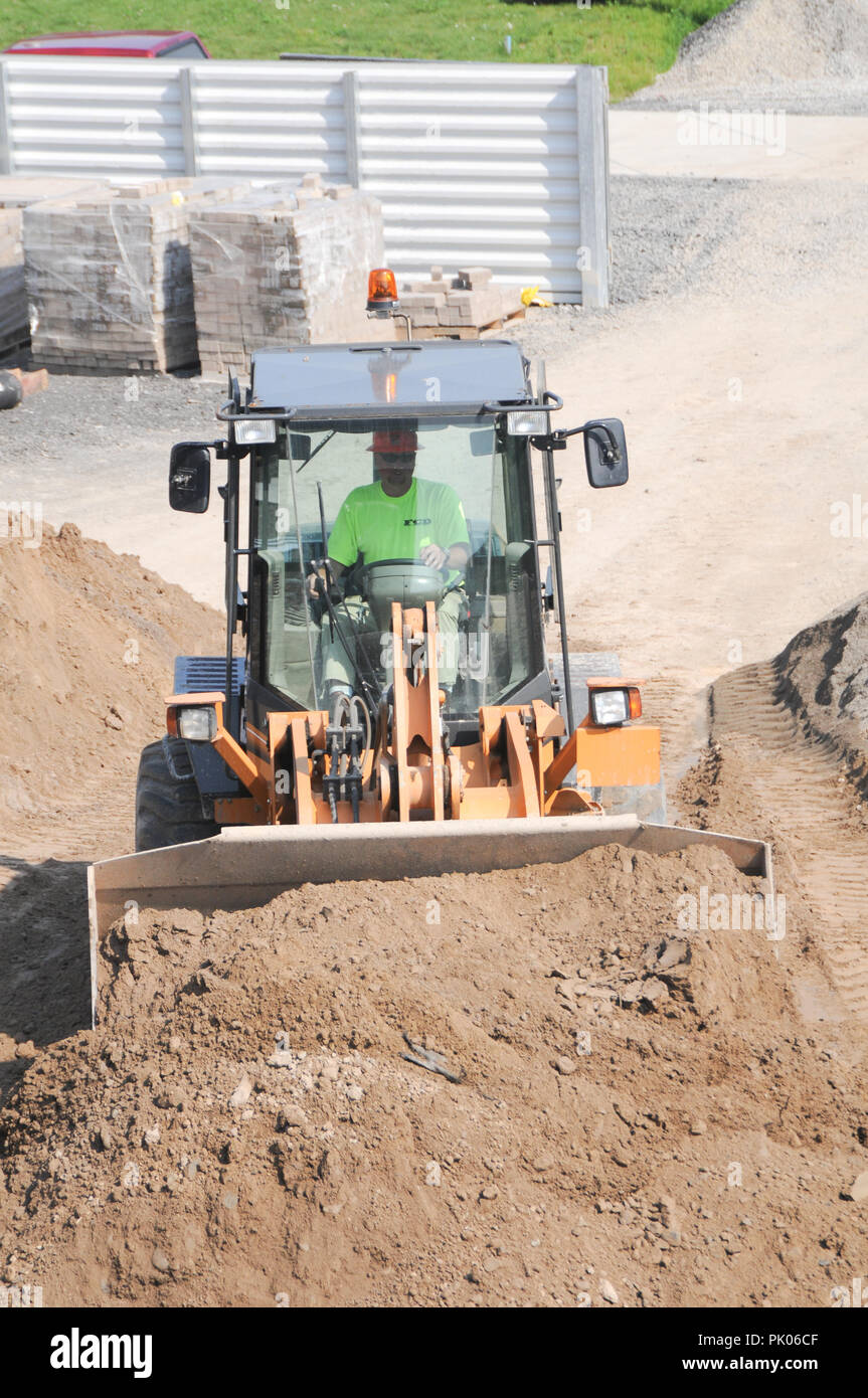Moving earth on a construction site Stock Photo - Alamy