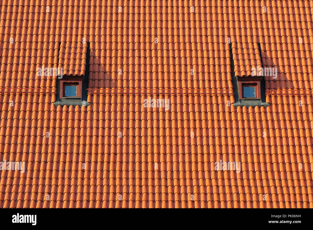 Roof Tiles roof with two small windows in the evening sun Stock Photo ...