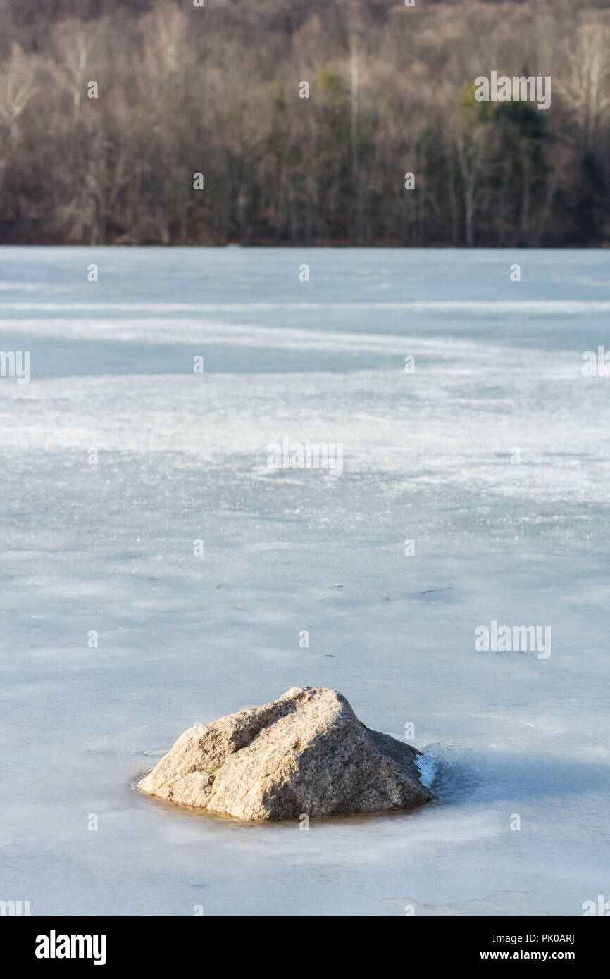Big rock in frozen lake Stock Photo - Alamy