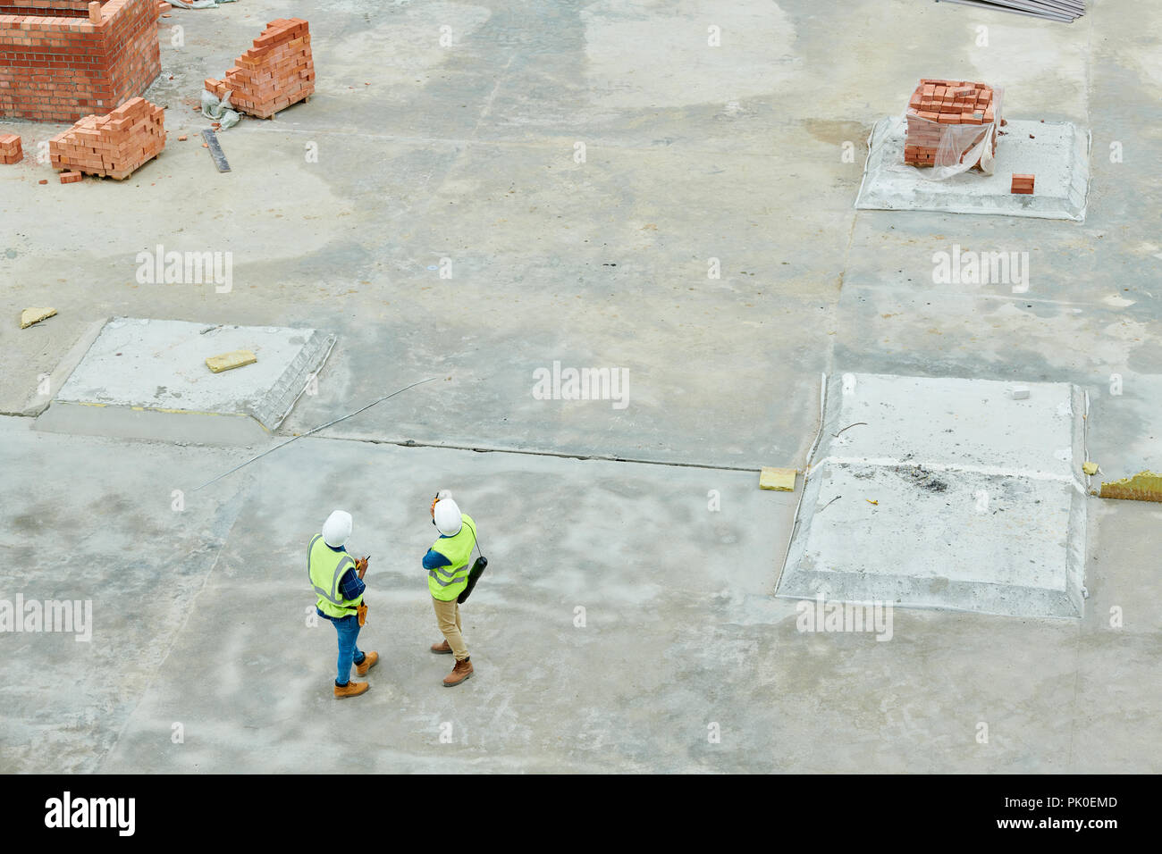 Builders working at construction site Stock Photo - Alamy
