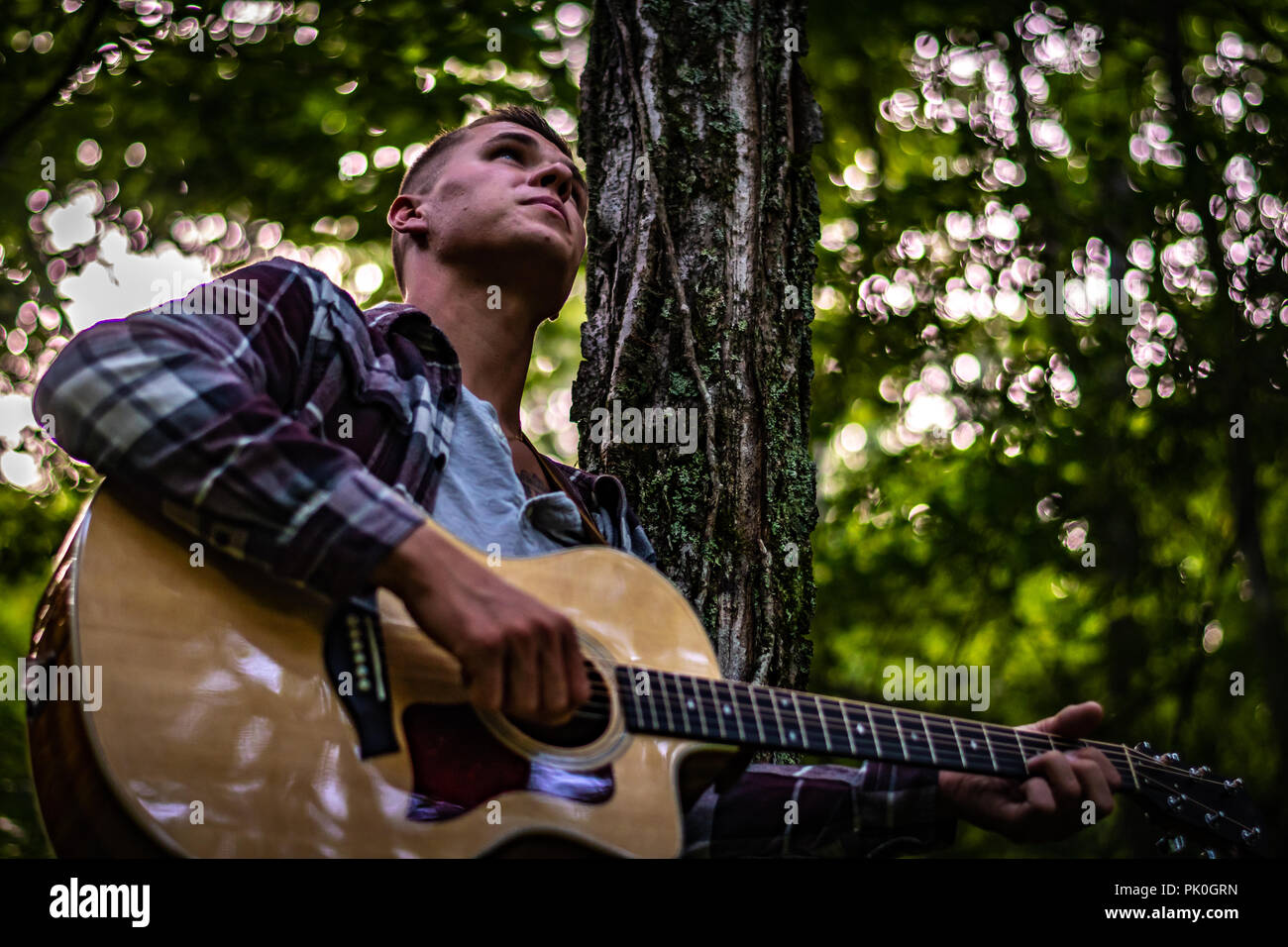 young man playing acoustic guitar in kentucky Stock Photo - Alamy