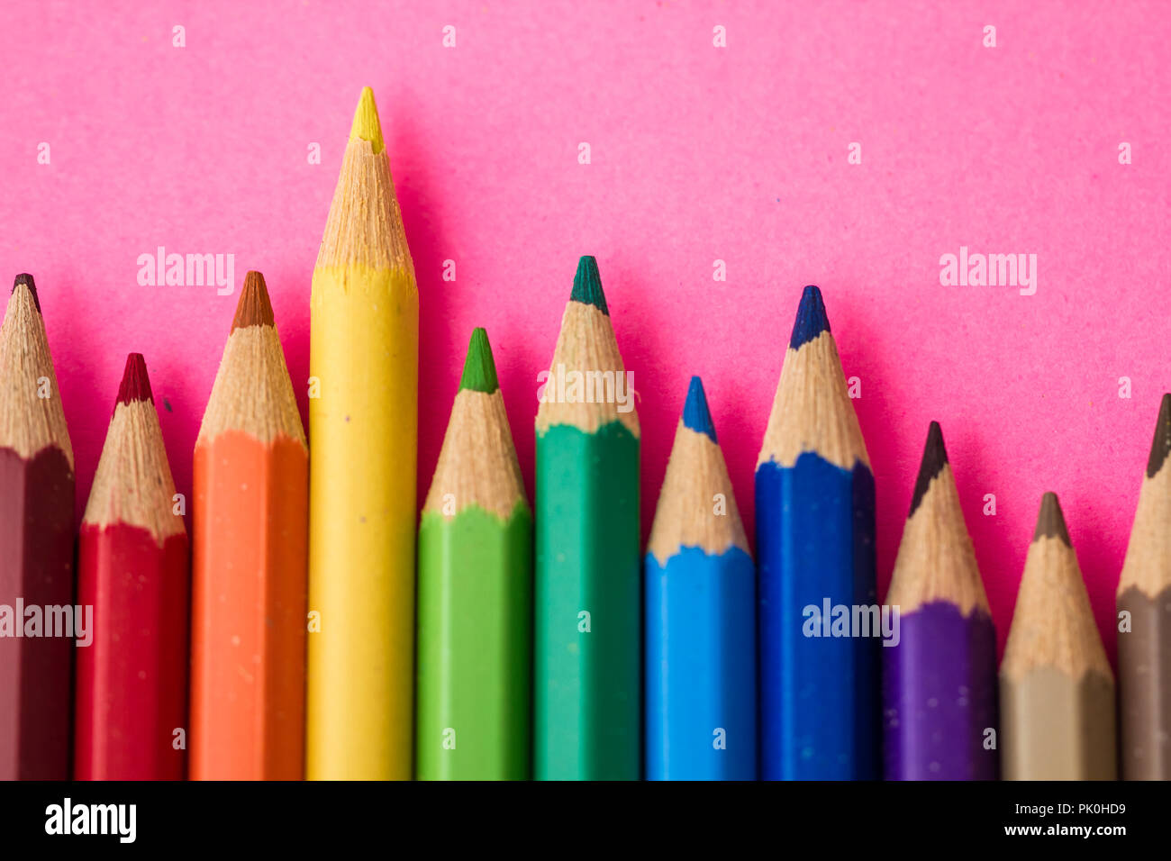 Bunch of colorful pencils scattered on pink background Stock Photo - Alamy