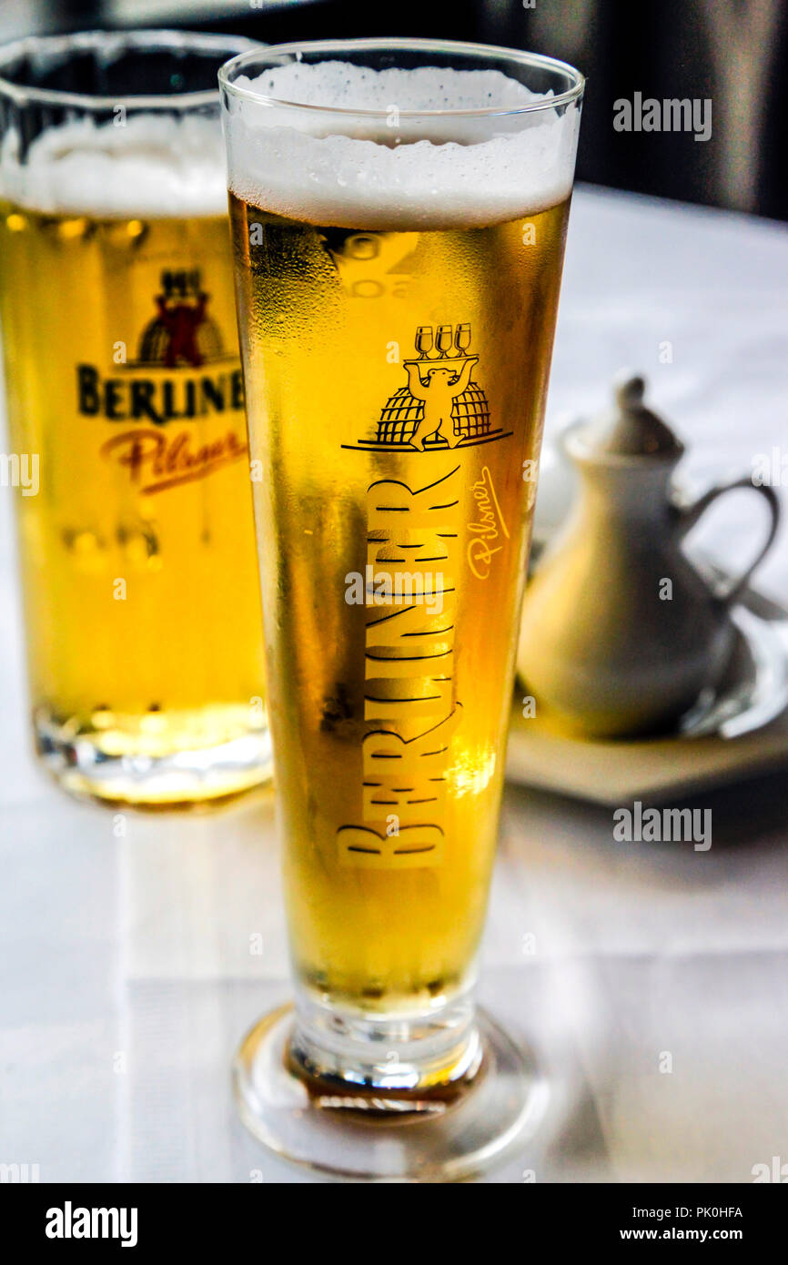 Glasses of Berliner Pilsner beer with foamy head sitting on a ...