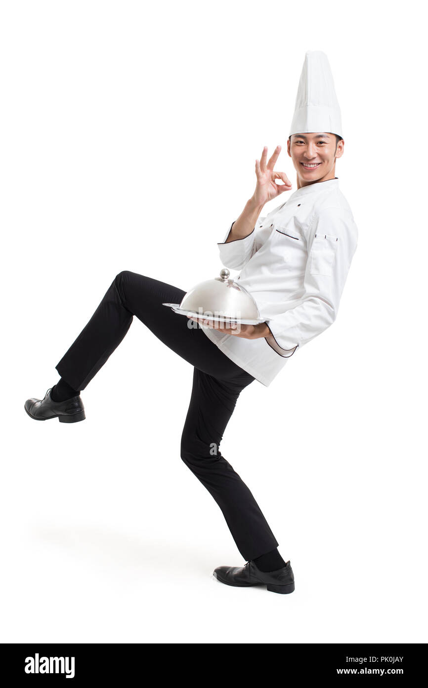 Cheerful chef serving food Stock Photo - Alamy