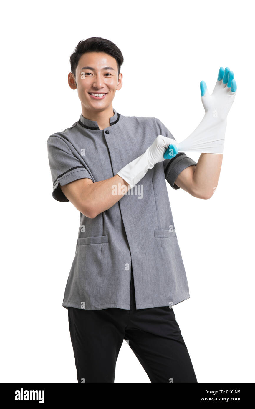 Cheerful cleaner wearing rubber gloves Stock Photo - Alamy