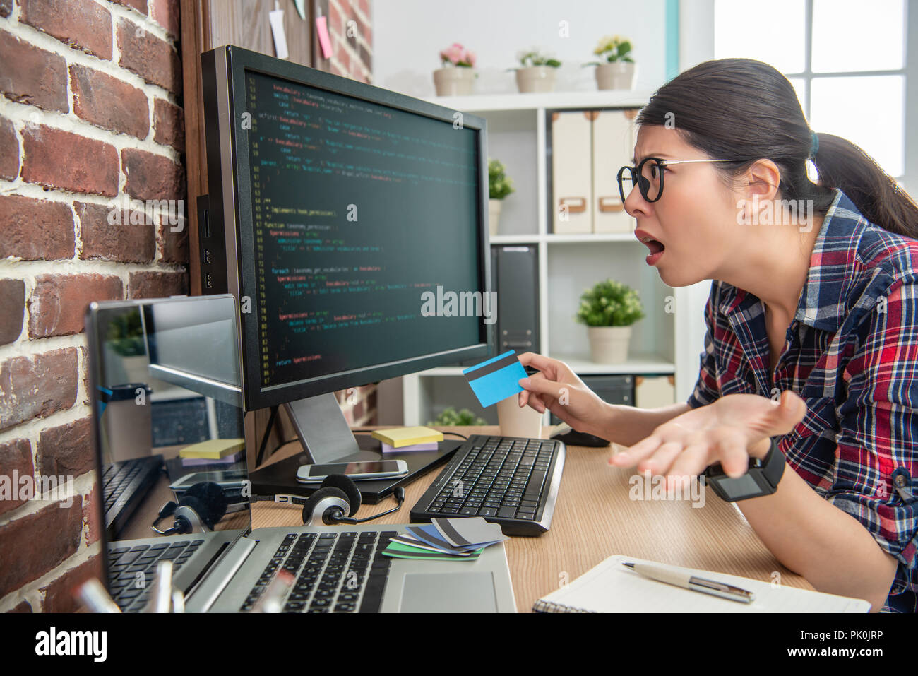 young office lady feeling very confused and puzzled by checking credit ...