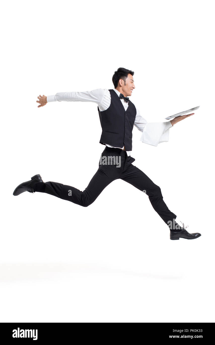 Cheerful young waiter serving food Stock Photo - Alamy