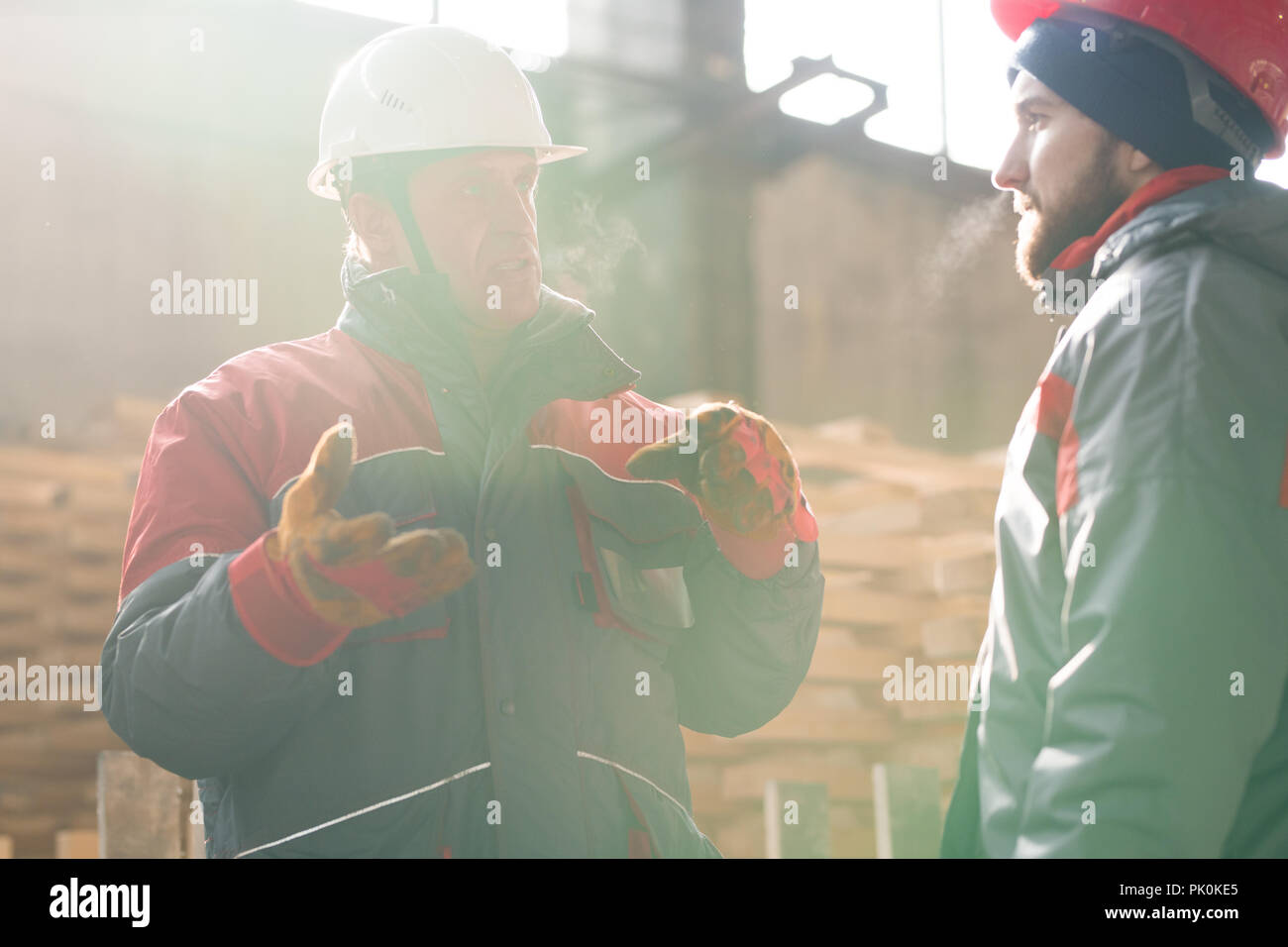 Two Workers Communicating Stock Photo - Alamy
