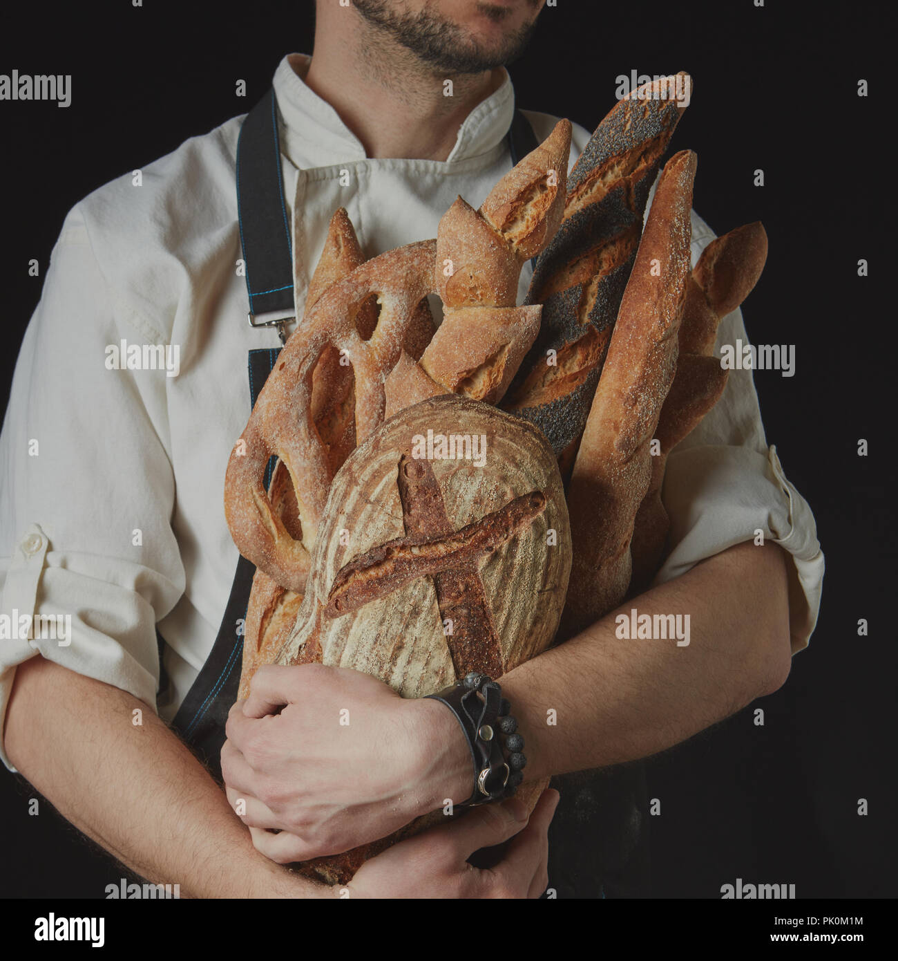 Variety of bread in hands of baker Stock Photo - Alamy