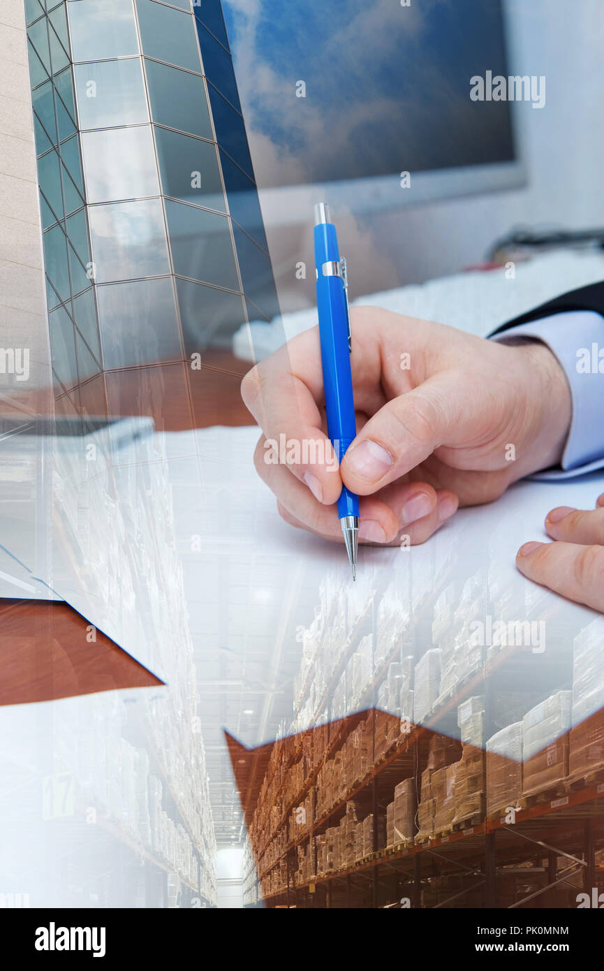 Hand with pen on desk signs documents Stock Photo - Alamy