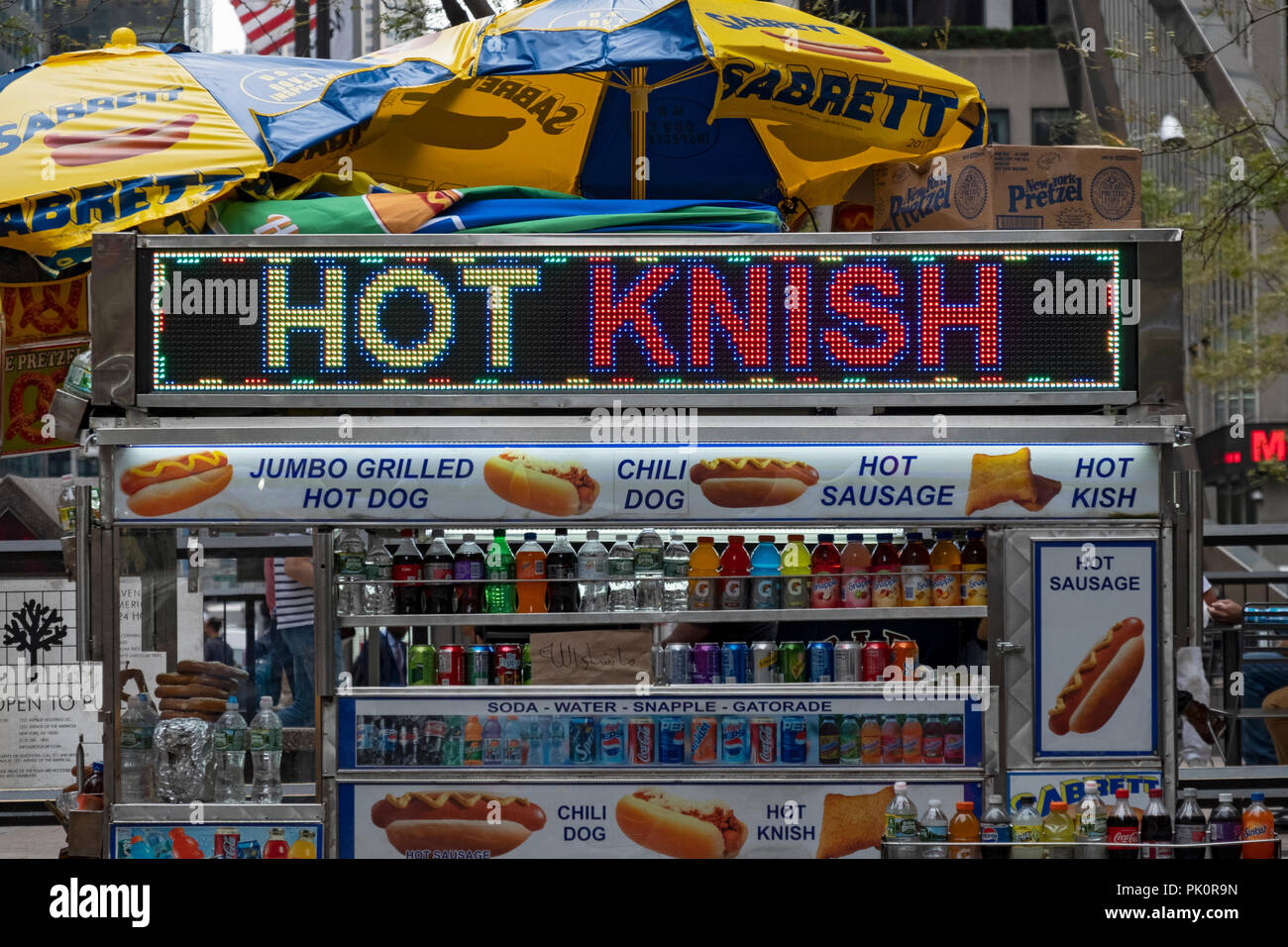 An outdoor food in Midtown Manhattan with a digital sign saying HOT ...