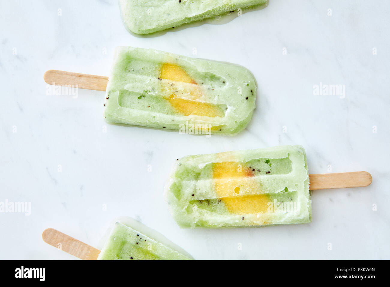 A set of delicious homemade berry ice cream lolly with a slice of mango ...