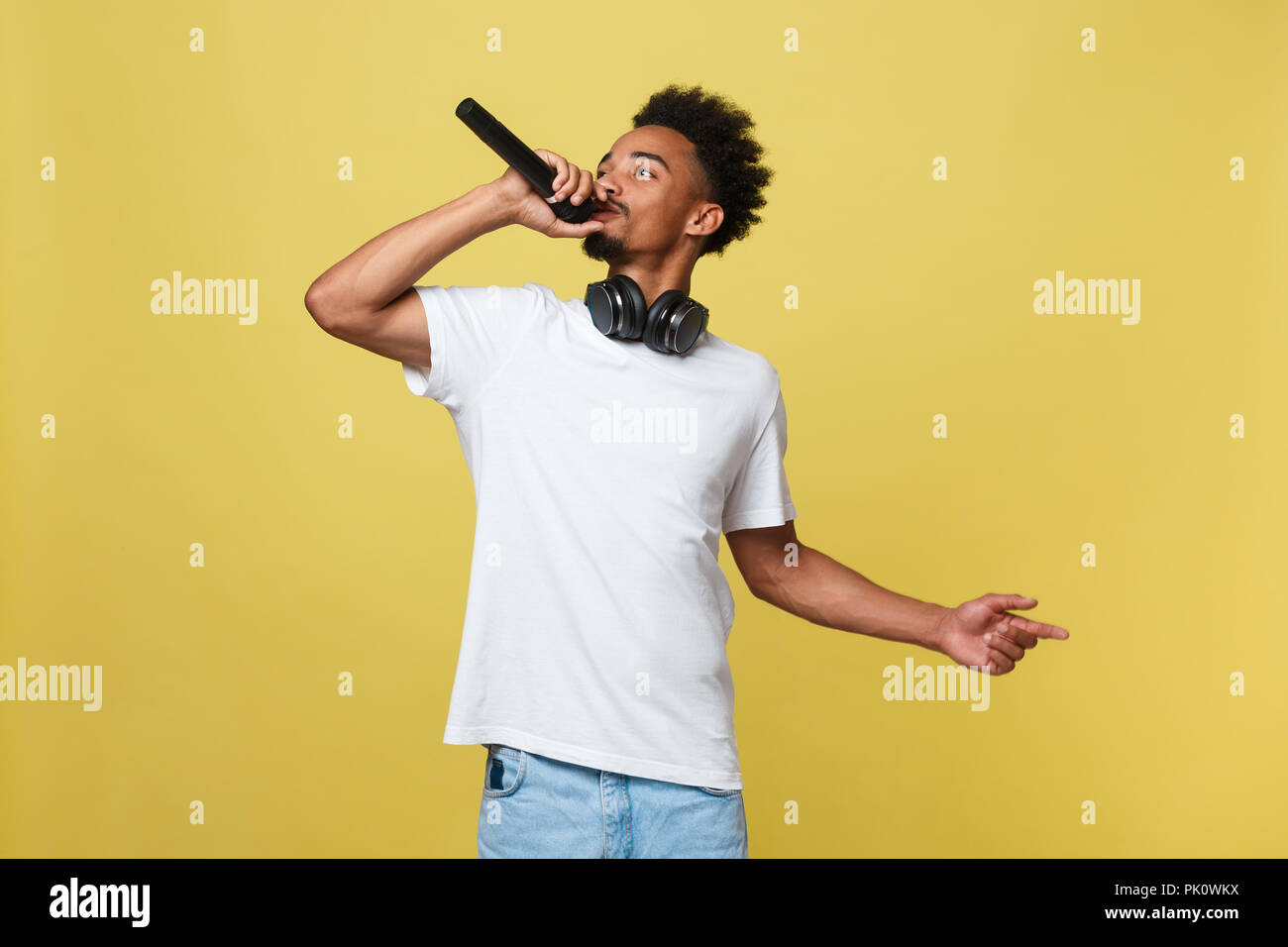 Young handsome African American Male Singer Performing with Microphone ...