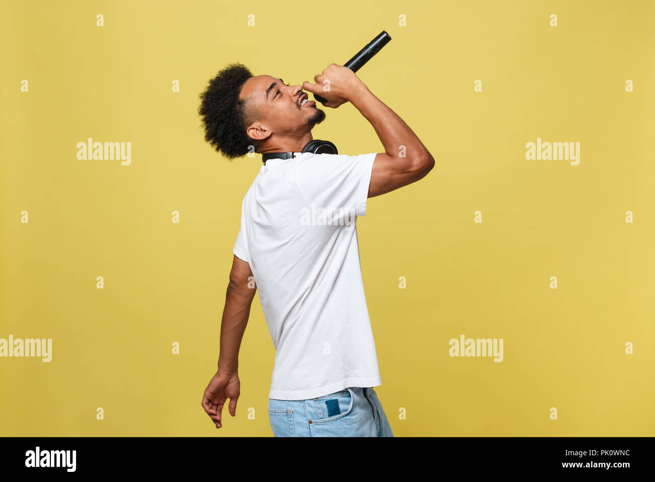 Young handsome African American Male Singer Performing with Microphone ...
