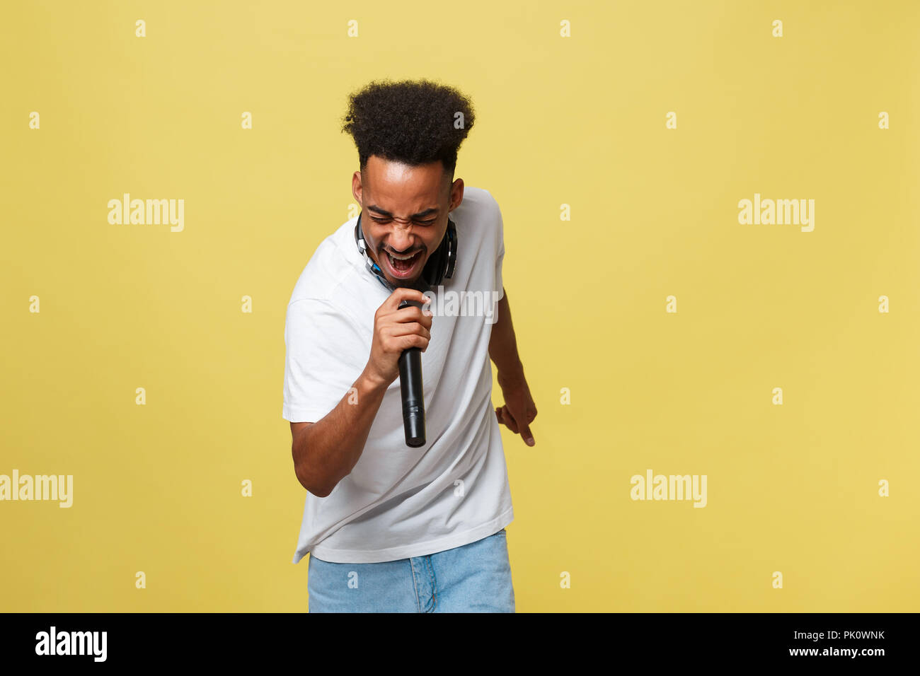 Young handsome African American Male Singer Performing with Microphone ...